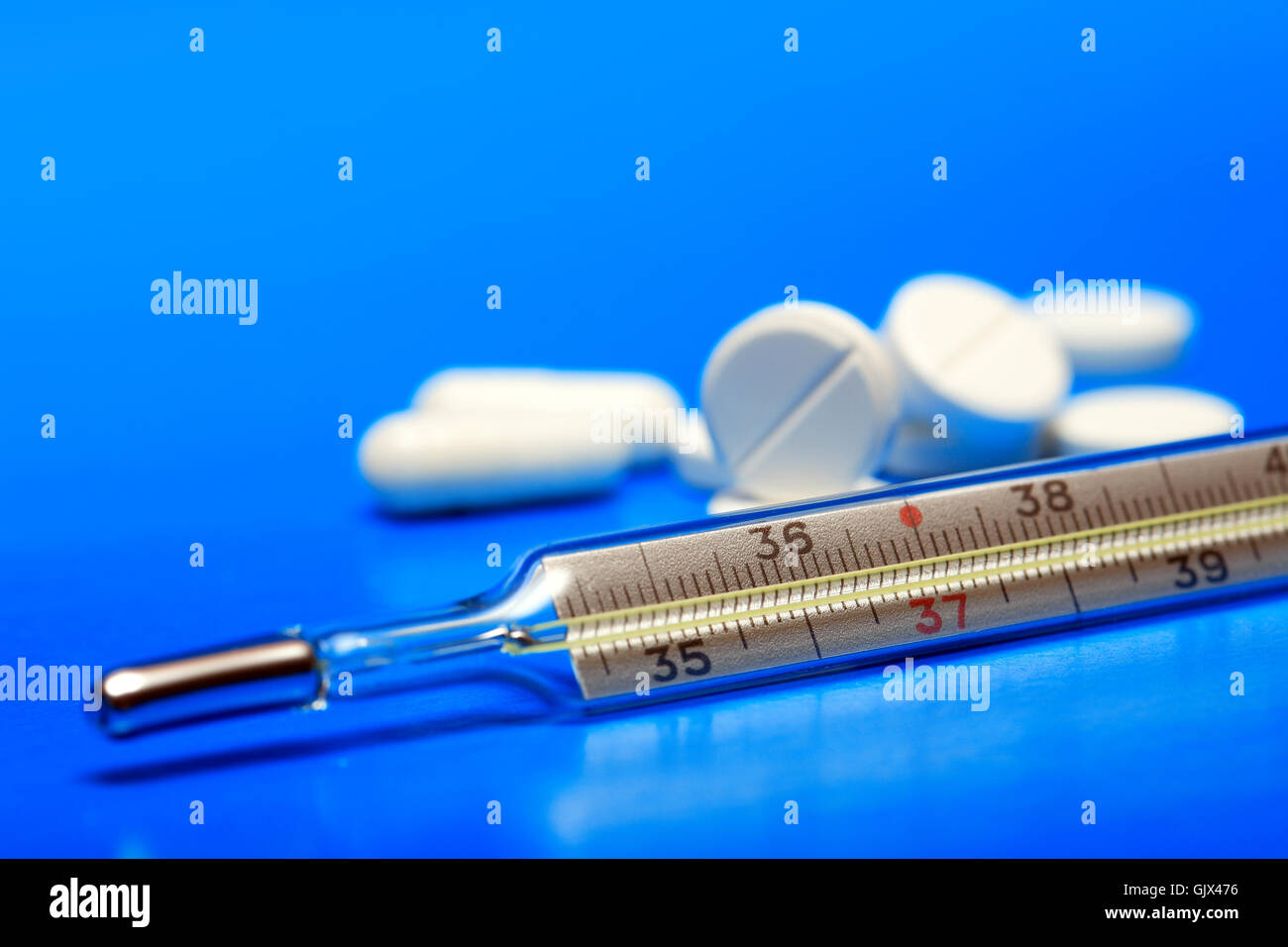 Pills And Thermometer Stock Photo - Alamy
