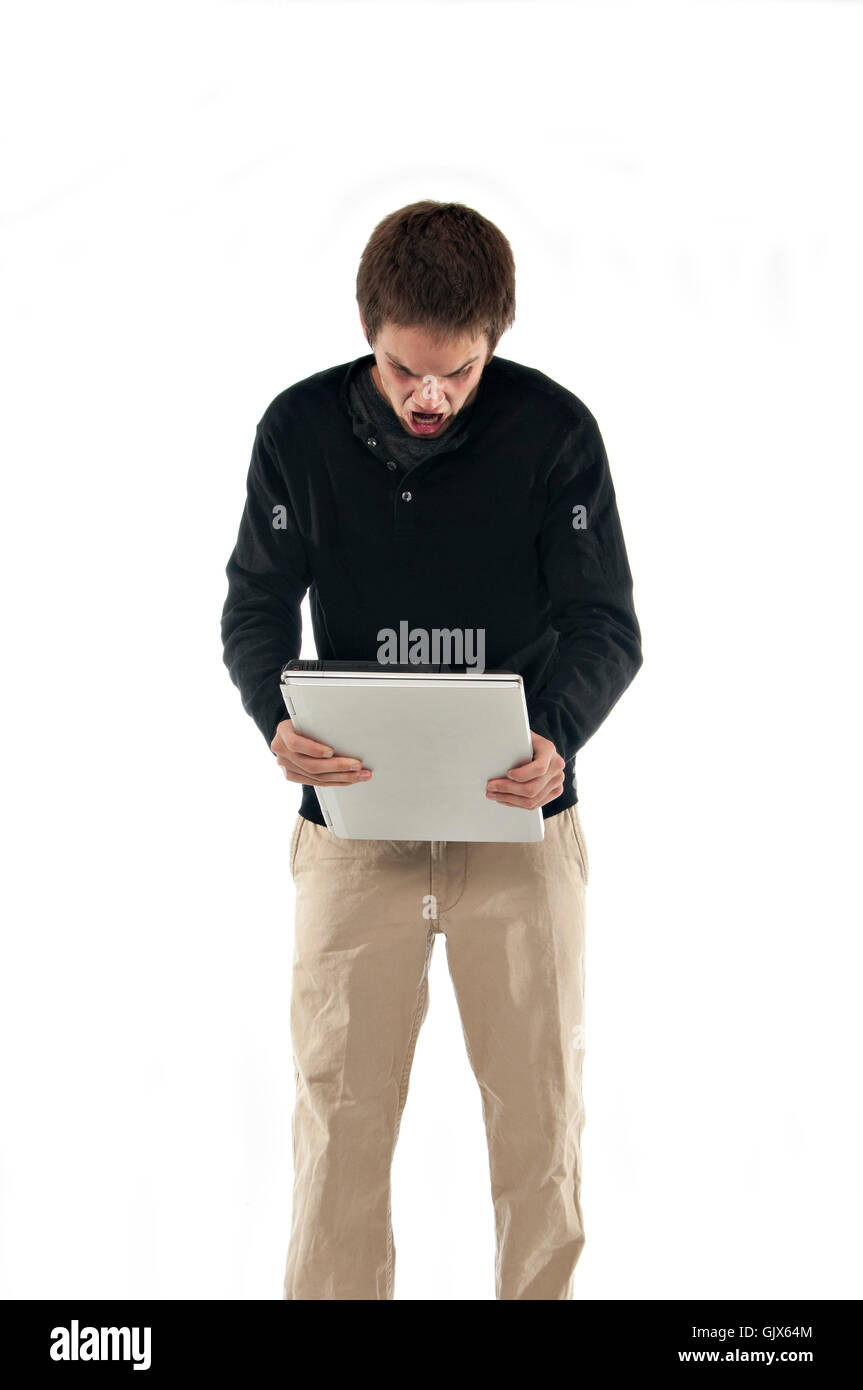 angry teenager holding laptop Stock Photo - Alamy