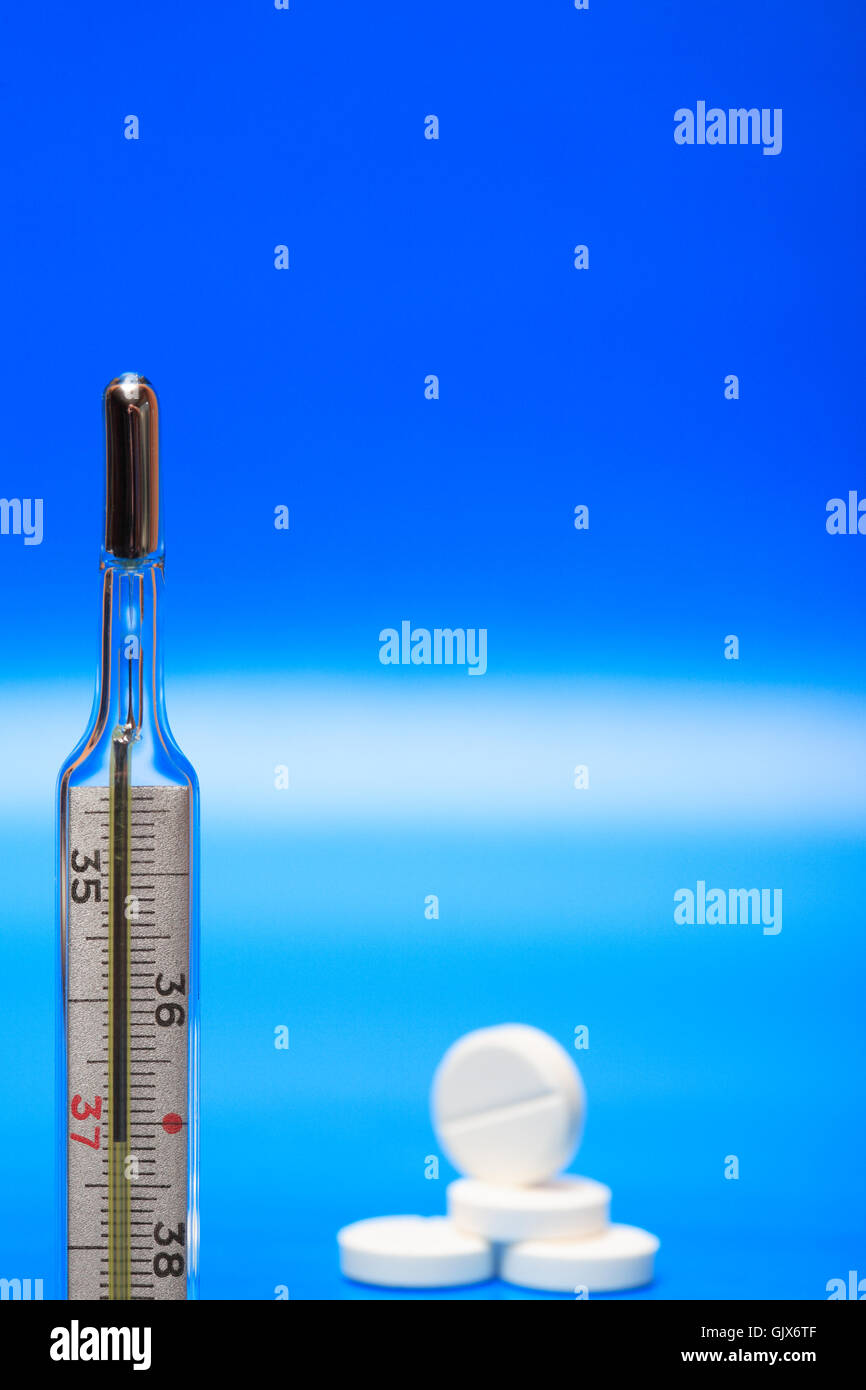 Pills And Thermometer Stock Photo - Alamy
