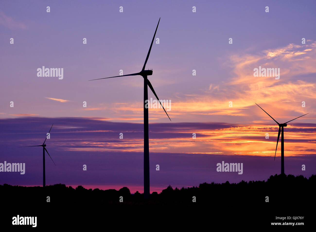 Wind turbine farm over sunset Stock Photo - Alamy