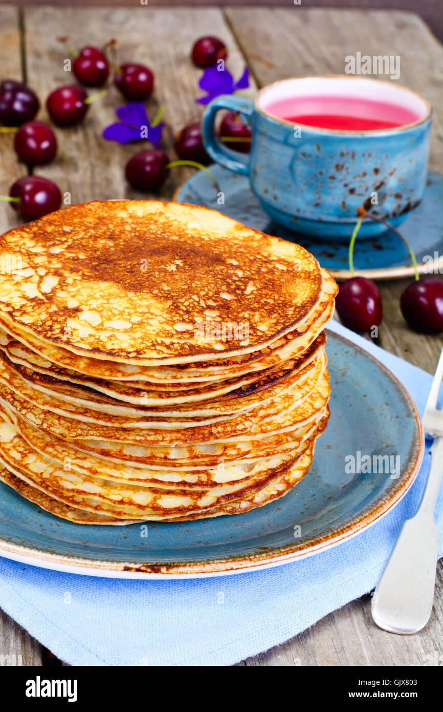 Tasty Pancakes Stack with Honey and Cherry Stock Photo - Alamy