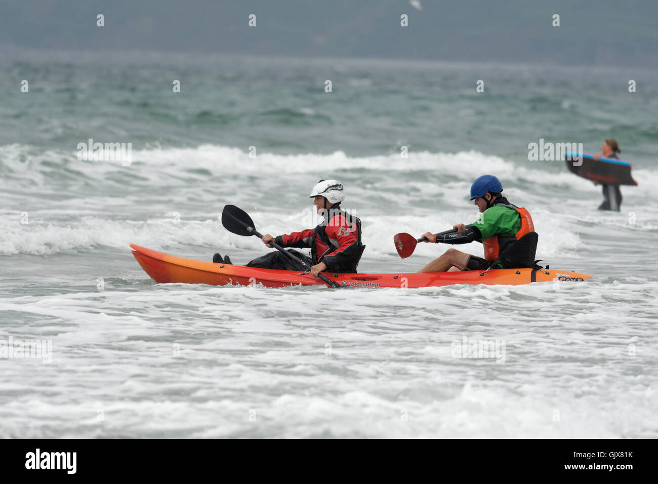 Kayaking on the beach in the surf at Porth Neigwl Stock Photo - Alamy