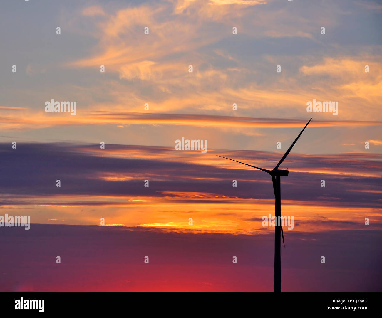 Wind turbine farm over sunset Stock Photo - Alamy