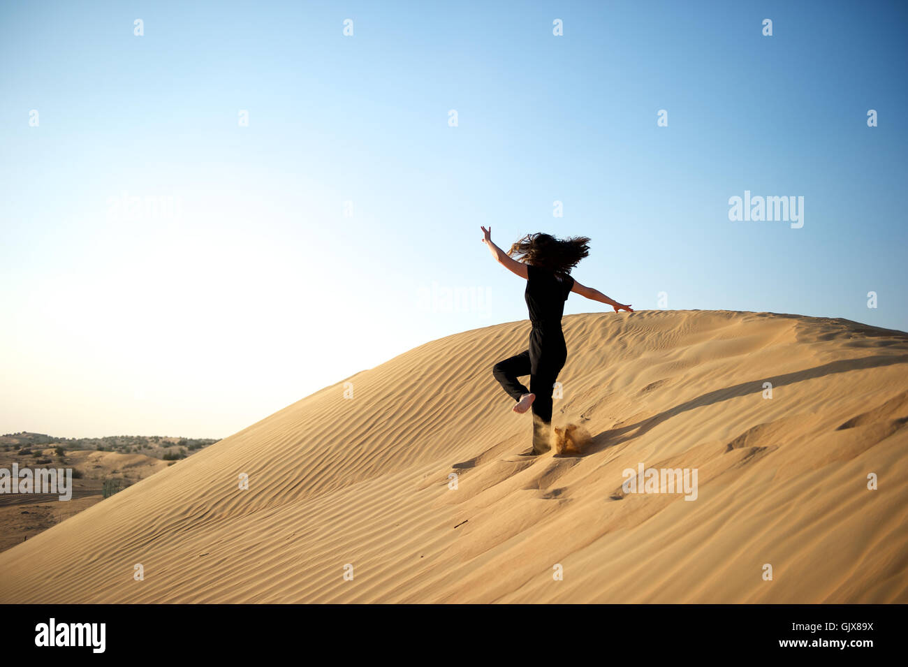 Woman in the desert Stock Photo - Alamy