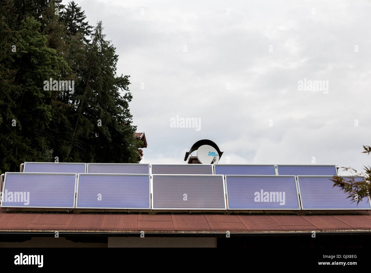 Roof house with solar panels and dish satellite Stock Photo - Alamy