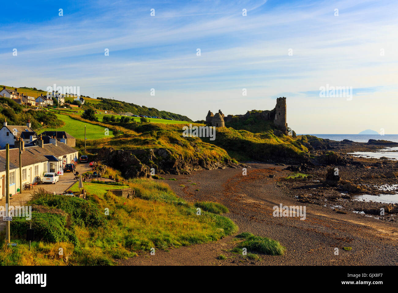 Village of Dunure with the ruined castle in evening sunlight, Ayrshire ...
