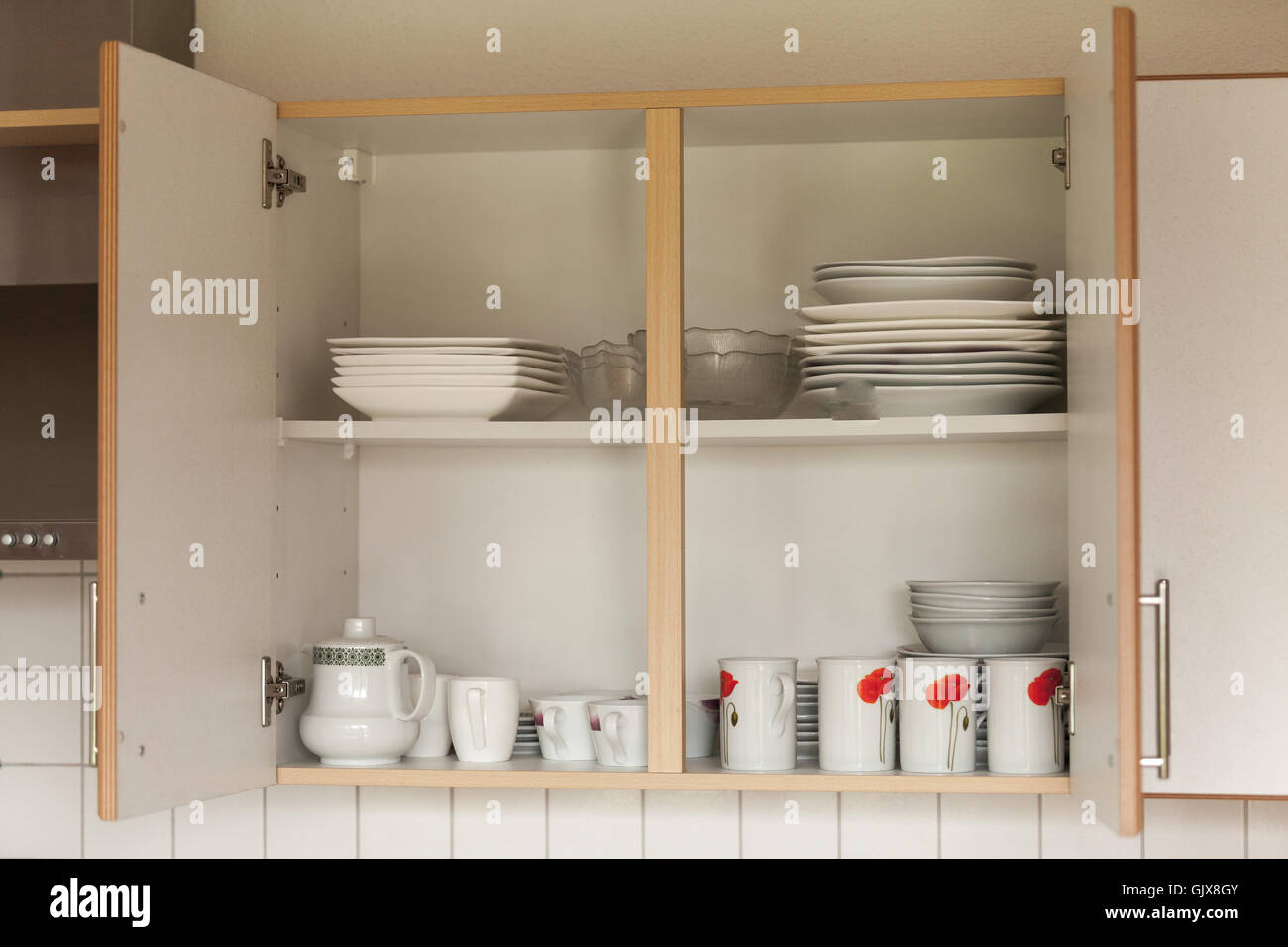 Tidy shelf with white dishes in a home kitchen Stock Photo - Alamy