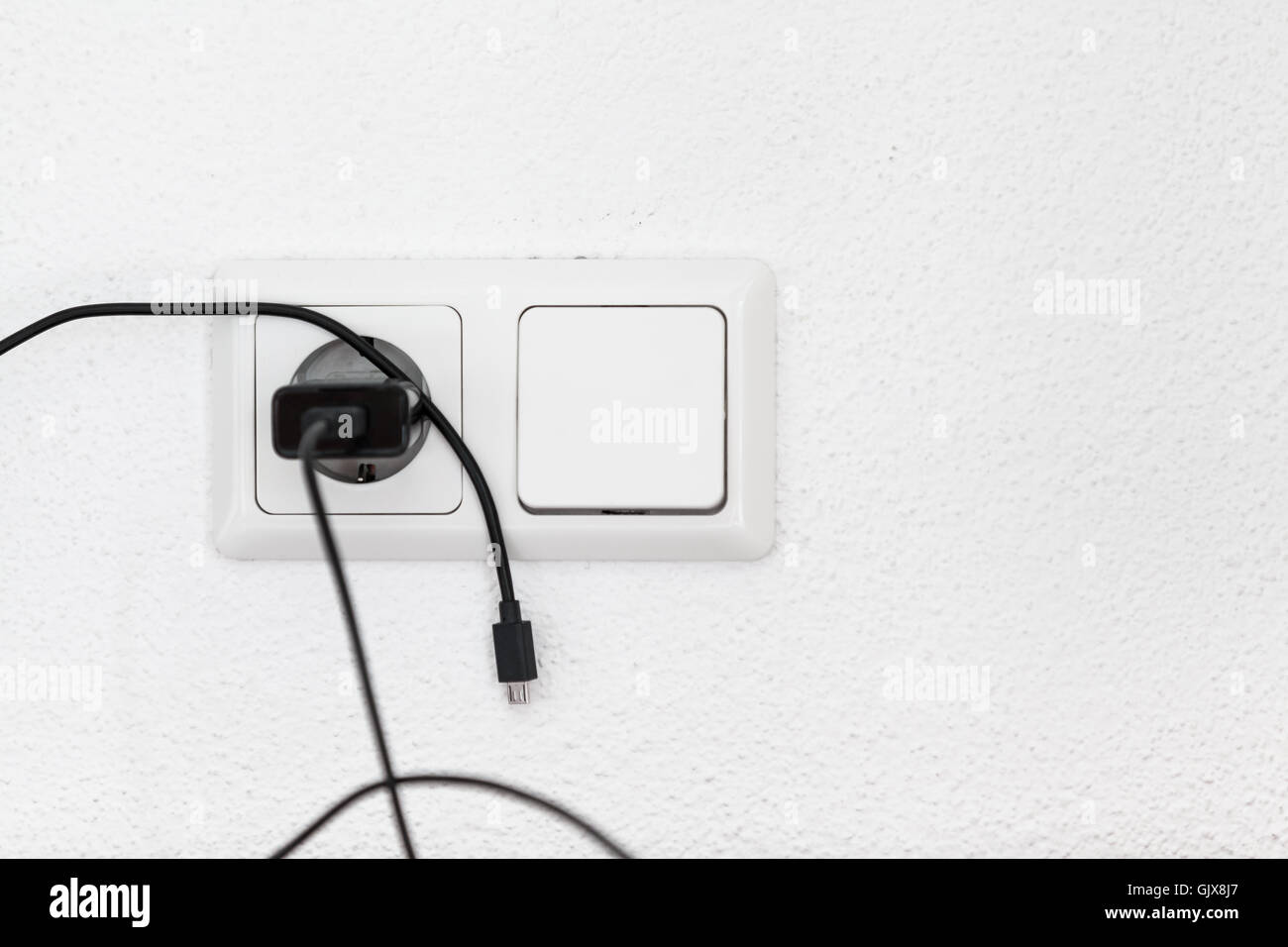 telephone charger wire, usb connection plugged in wall outlet Stock ...