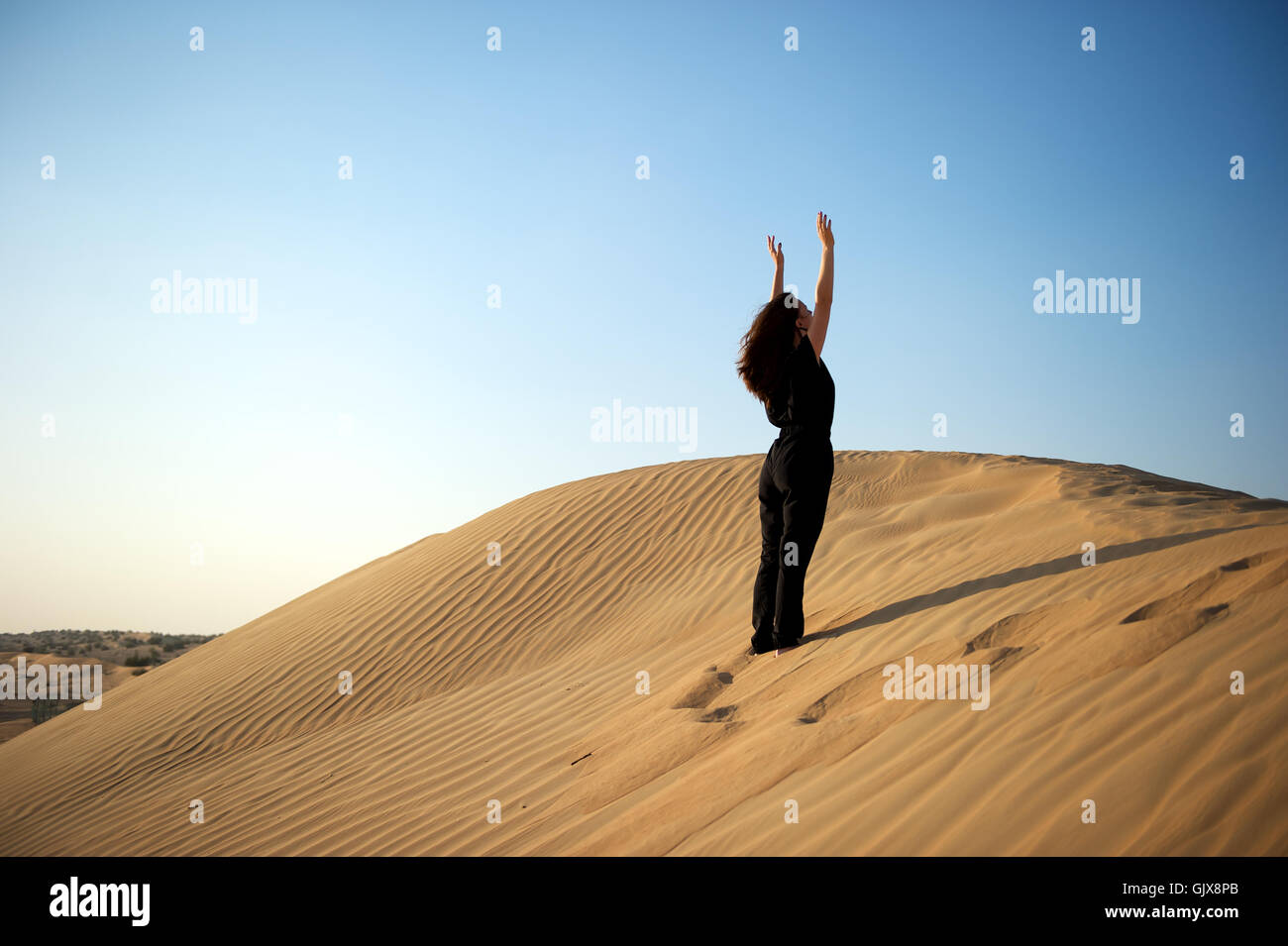 Woman in the desert Stock Photo - Alamy