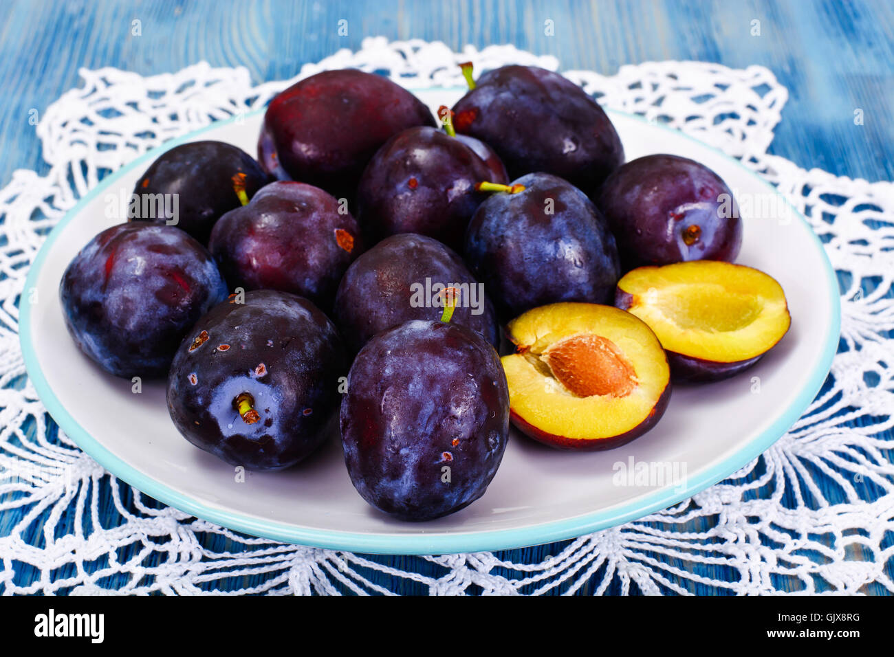 Juicy Ripe Plums on Woody Background Stock Photo - Alamy