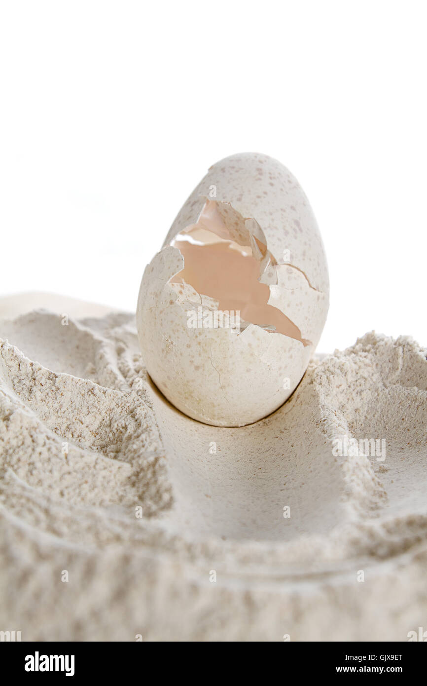 Craked egg on flour Stock Photo - Alamy