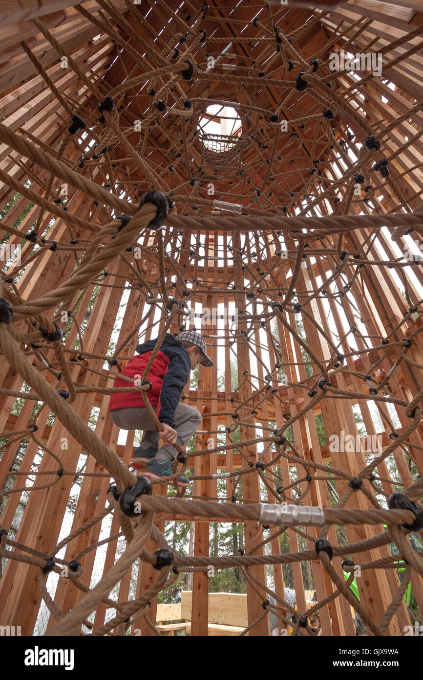 Boy climbing rope tower in Spruce Tree Castle at Rosenalm park near ...