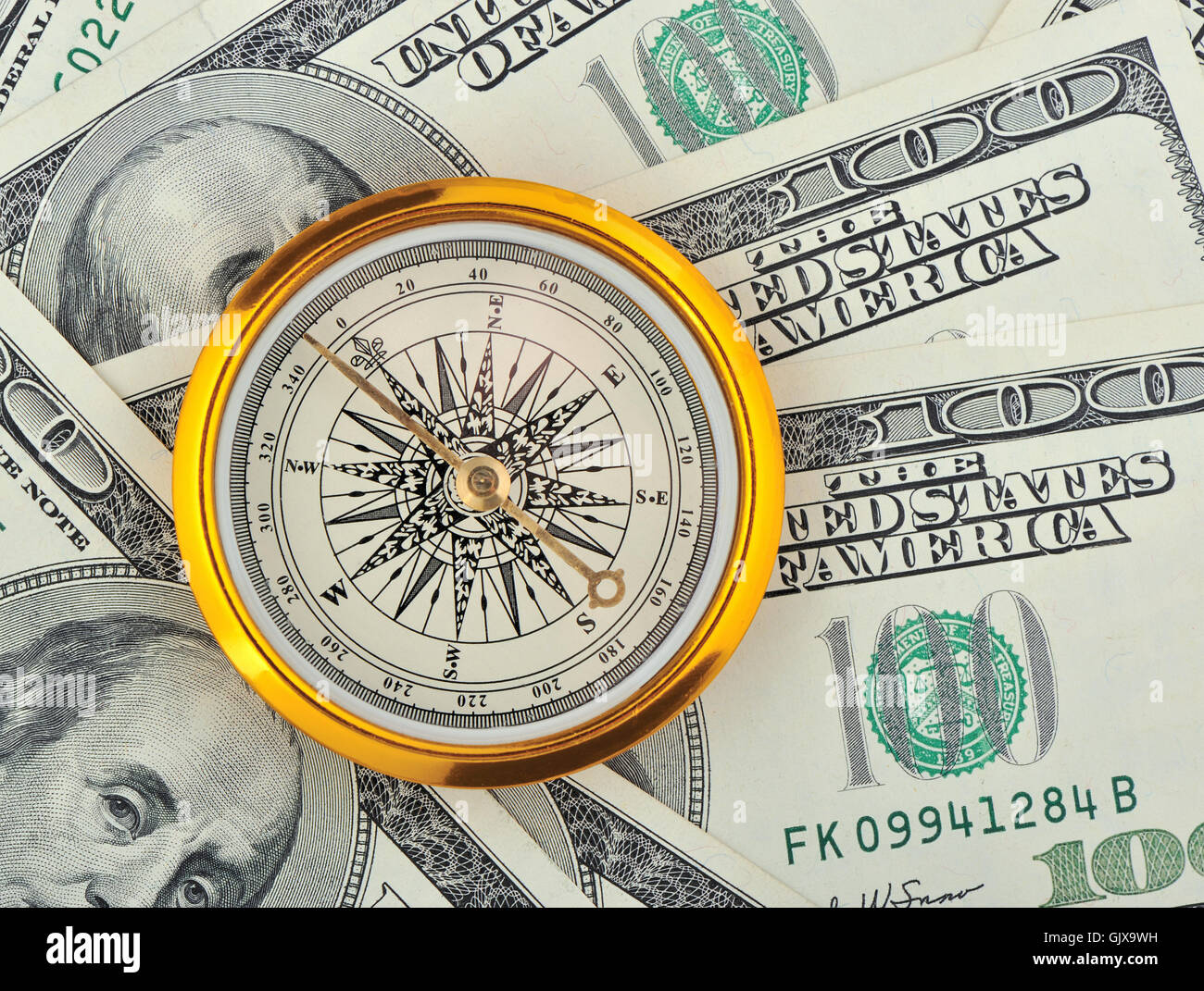 Dollars and compass Stock Photo - Alamy