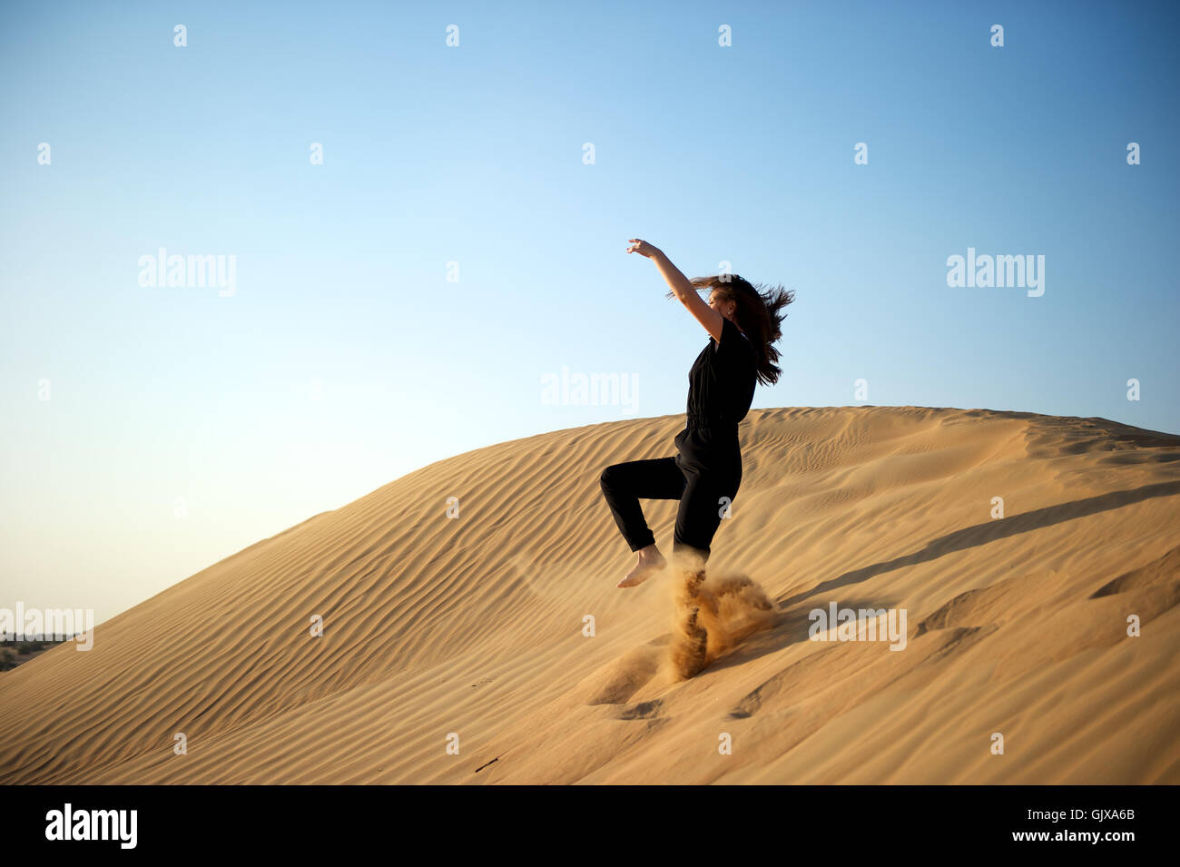 Woman in the desert Stock Photo - Alamy