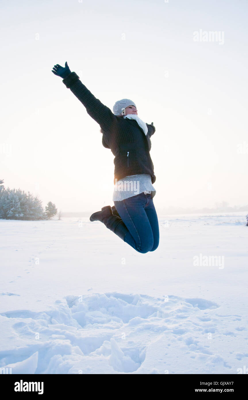 Girl jumping at snow Stock Photo - Alamy