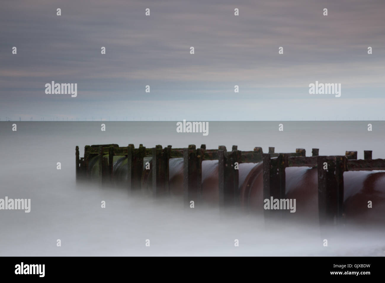 Pensarn beach in North Wales with the remains f the old sewage outflows ...