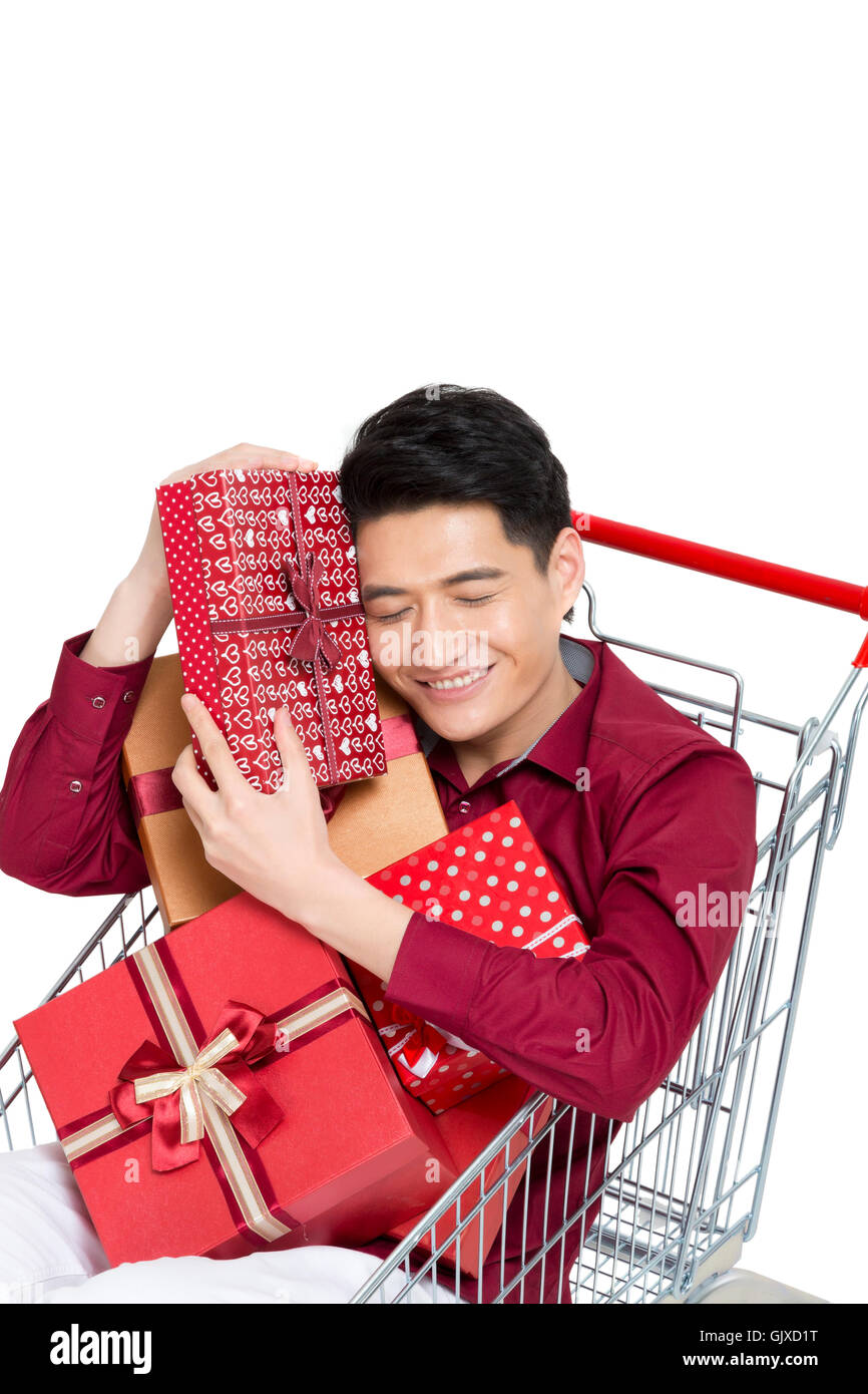Studio shot Young man sitting in the cart Stock Photo - Alamy