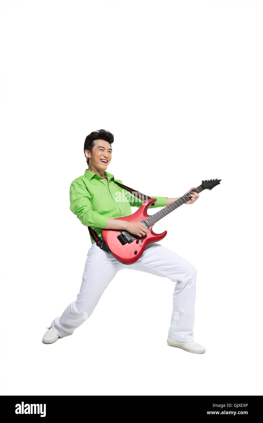Fashion studio shot of young men while playing the guitar and dancing ...