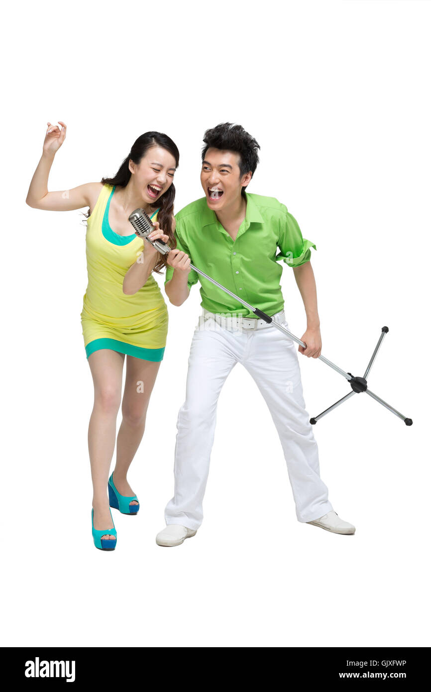 Studio shot fashion young people singing and dancing Stock Photo - Alamy