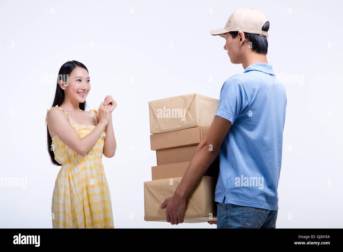 Work clothes studio shot young male and female courier customer Stock ...
