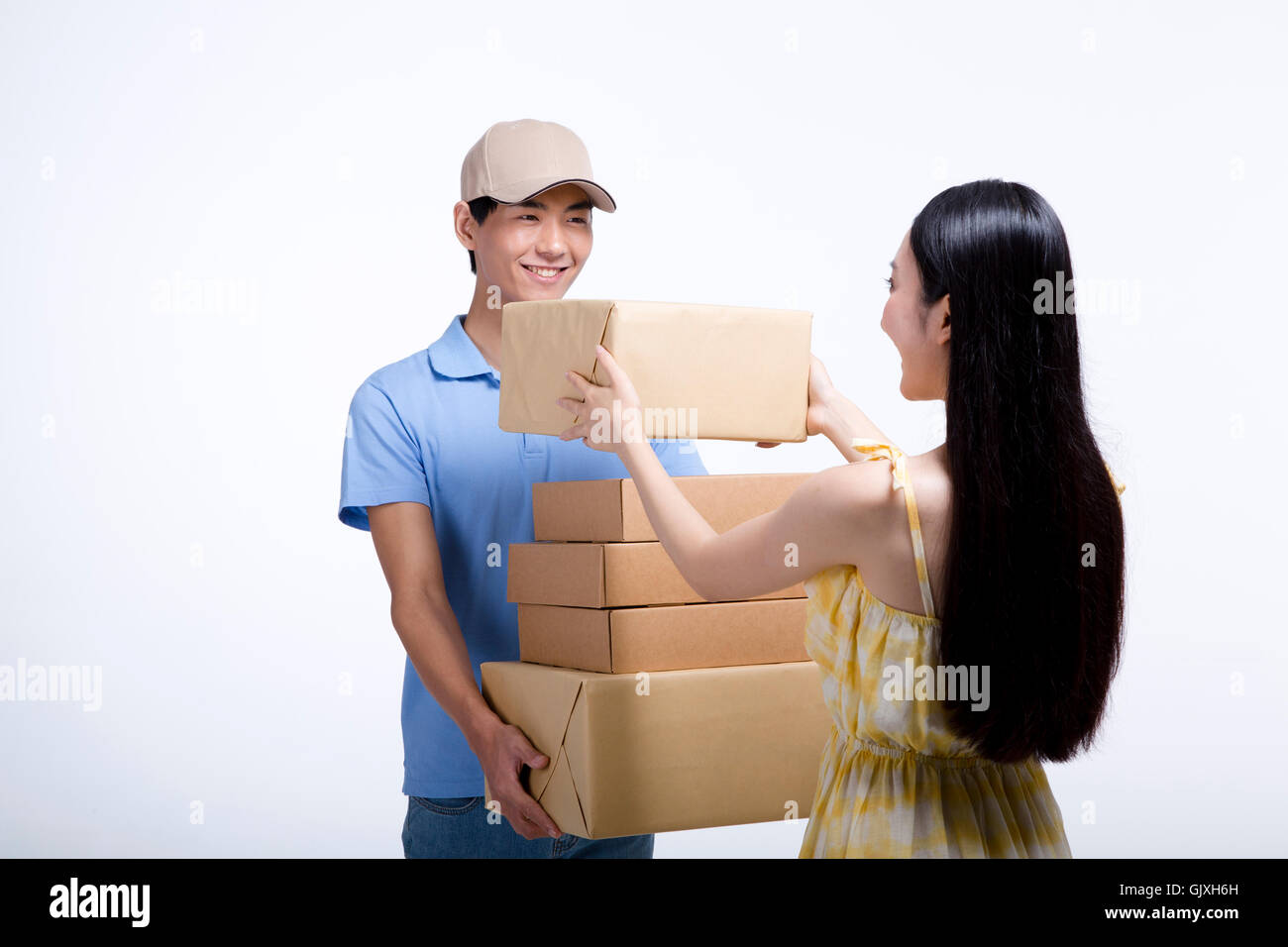 Work clothes studio shot young male and female courier customer Stock ...