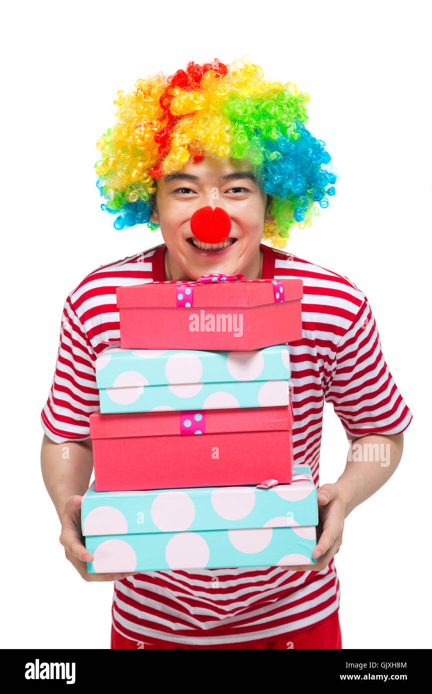 Fashion studio shot clown holding gift boxes Stock Photo - Alamy