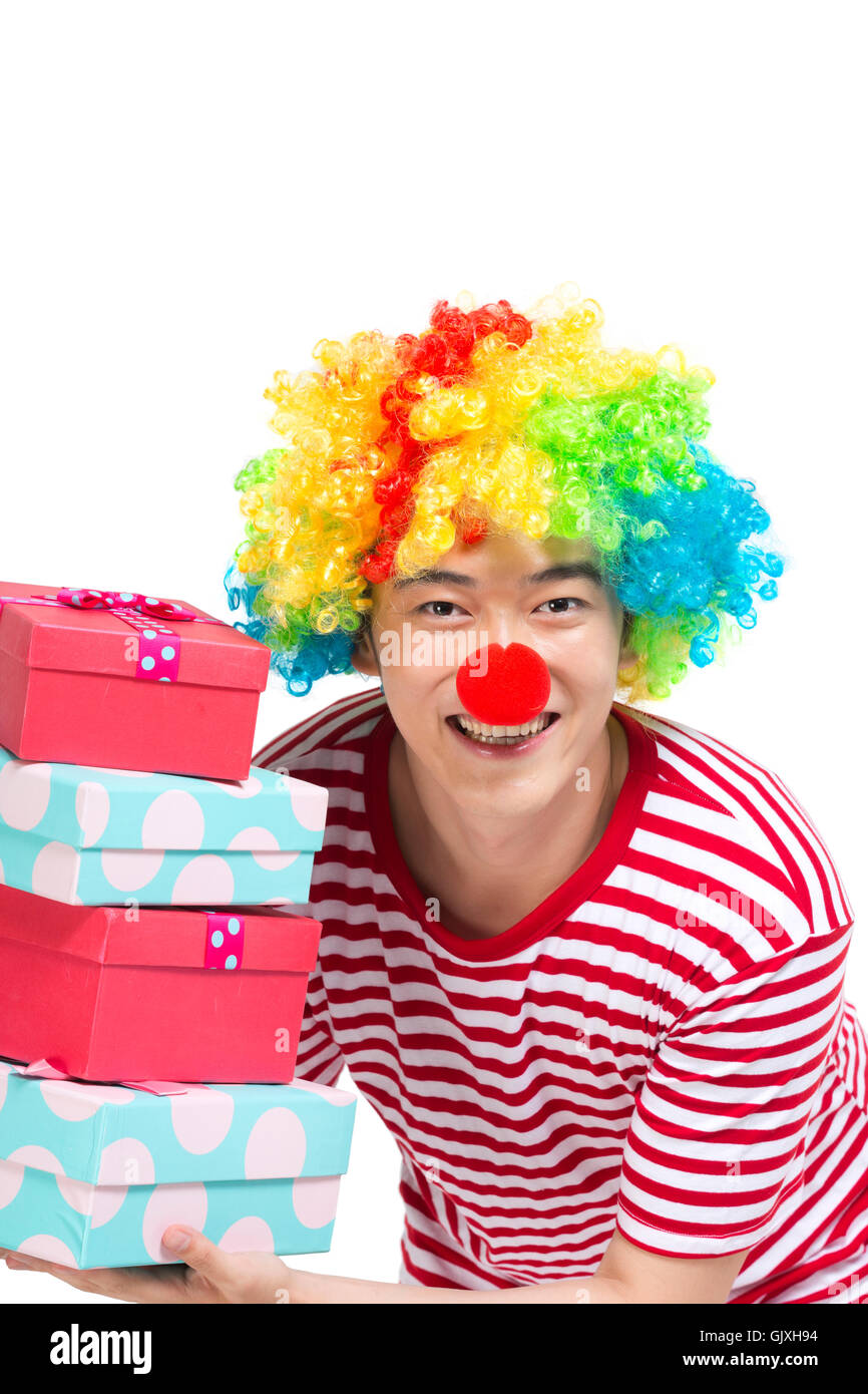 Fashion studio shot clown holding gift boxes Stock Photo - Alamy