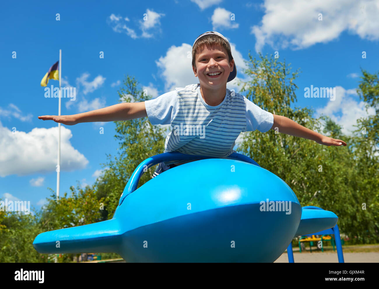 child fly on blue airplane attraction in park, happy childhood, summer ...