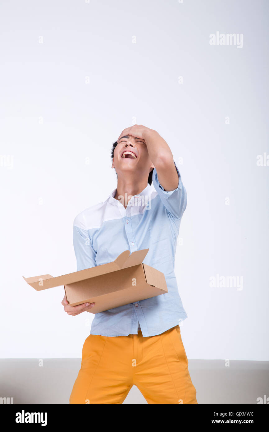Studio shot Young man show merchandise Stock Photo - Alamy
