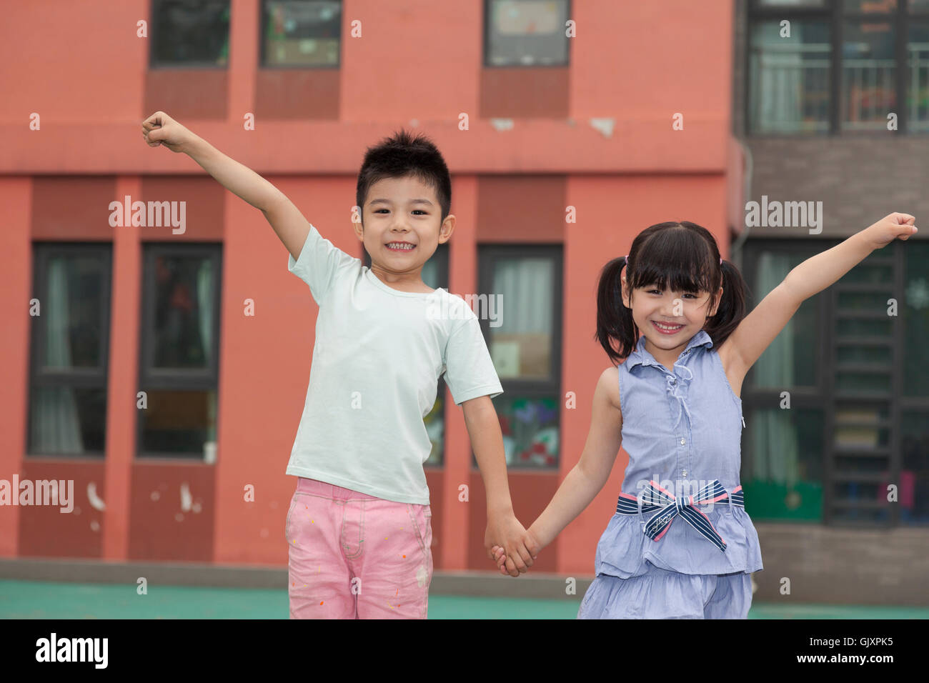 Children in kindergarten hand in hand Stock Photo - Alamy