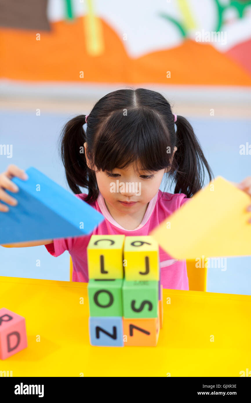 Little girl playing with blocks Stock Photo - Alamy