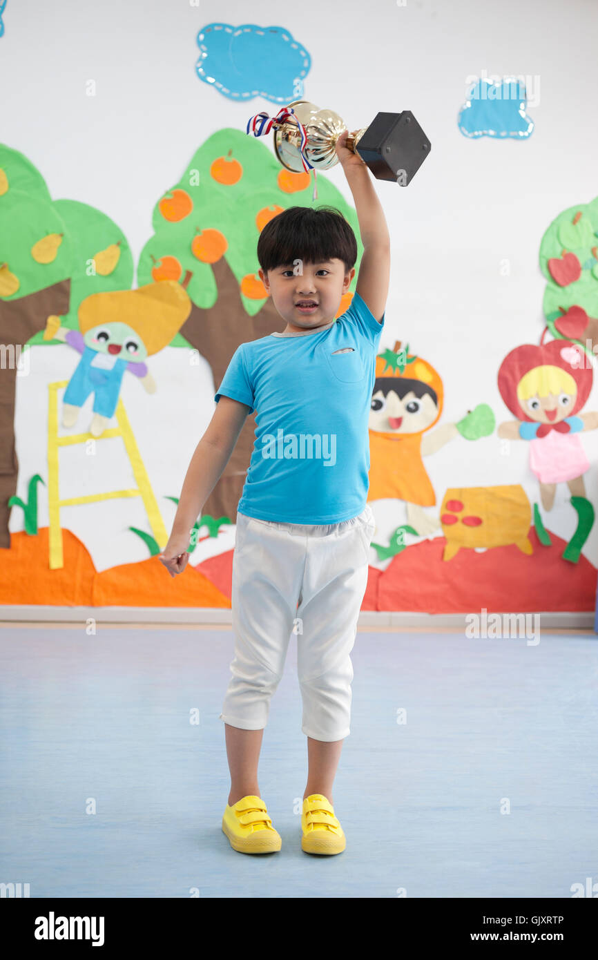 The boy lifted the trophy Stock Photo - Alamy
