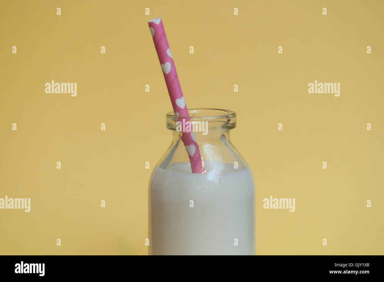 Bottle of fresh milk on a yellow background Stock Photo - Alamy