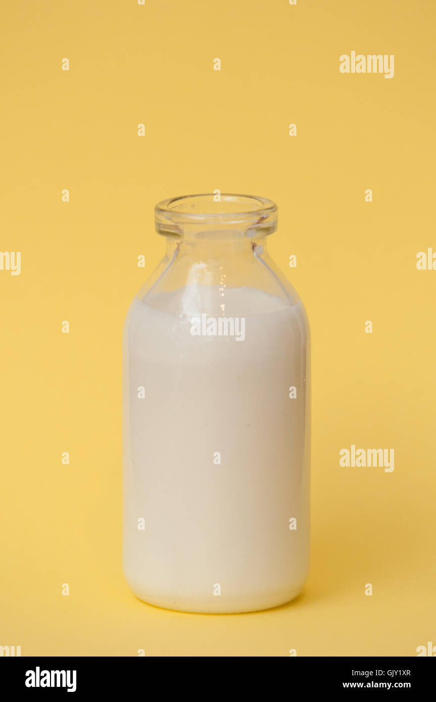 Bottle of fresh milk on a yellow background Stock Photo - Alamy