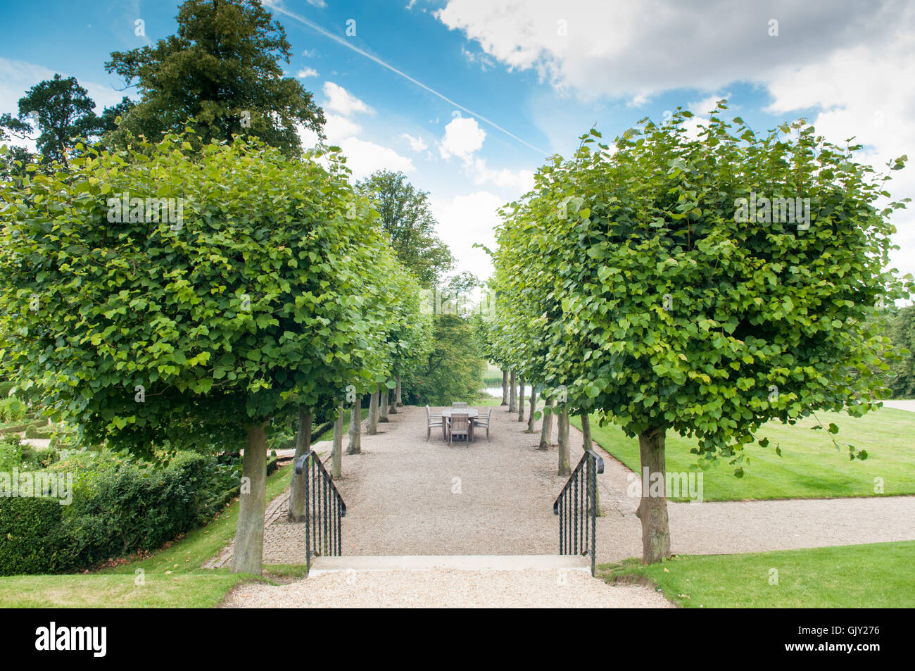 Formal garden entrance with shaped hedges and trees Stock Photo - Alamy