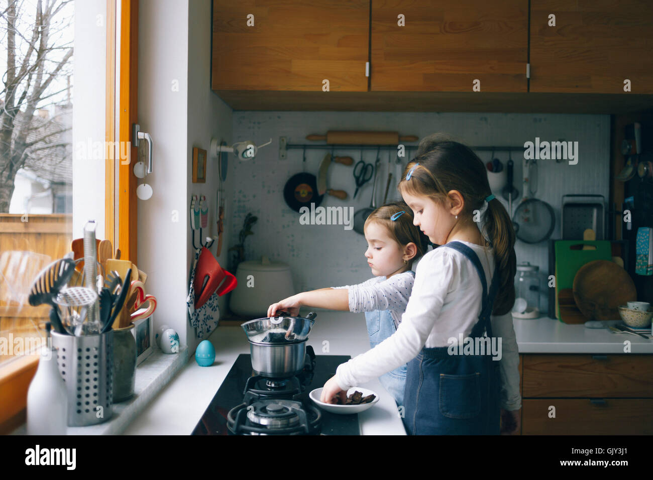 Girls melting chocolate in a kitchen Stock Photo - Alamy