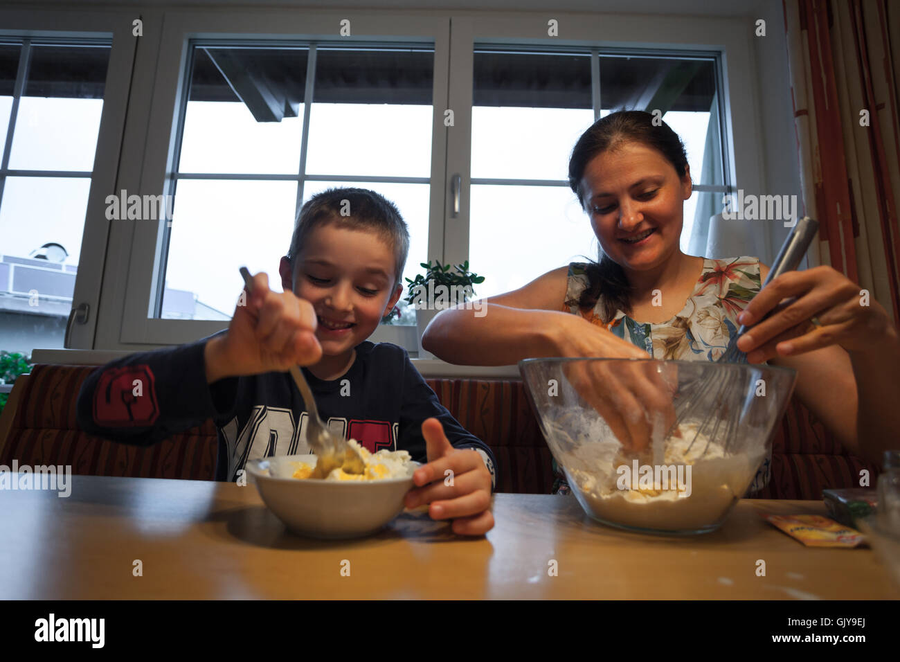 Boy and mom having fun cooking together Stock Photo - Alamy