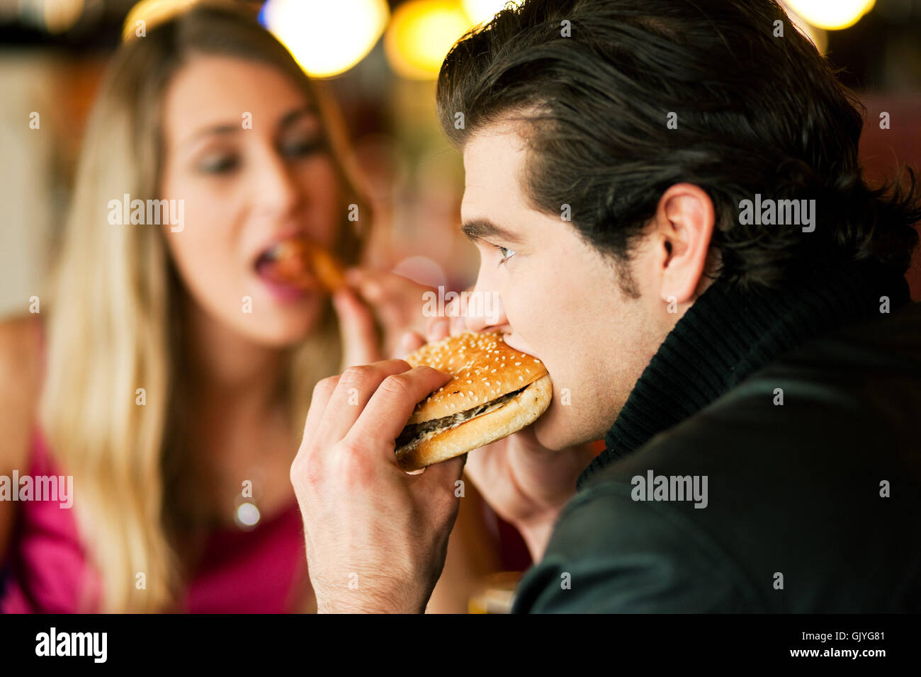 couple in restaurant eating fast food Stock Photo - Alamy
