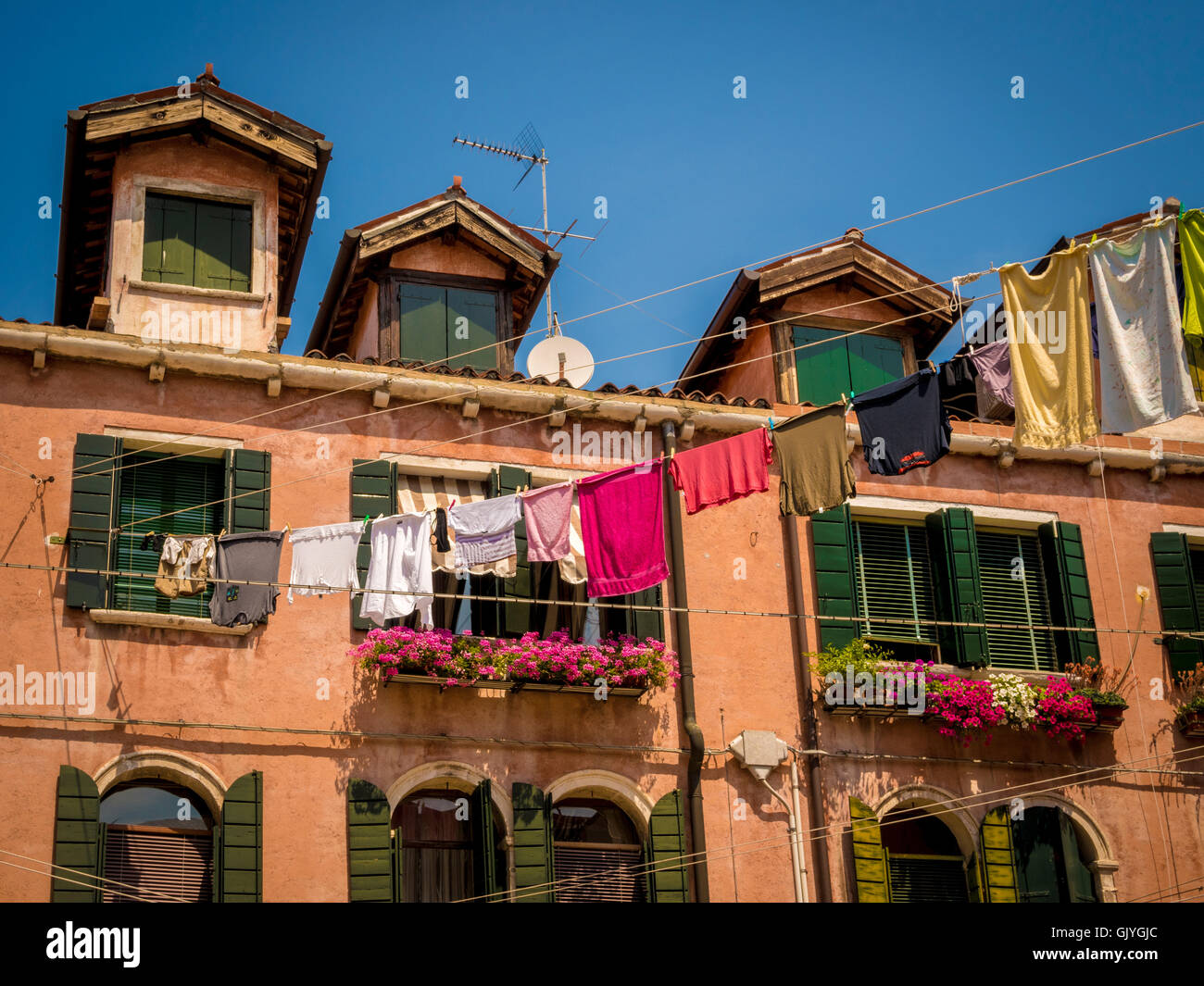 Traditional buildings with venetians blinds and window shutters, with ...