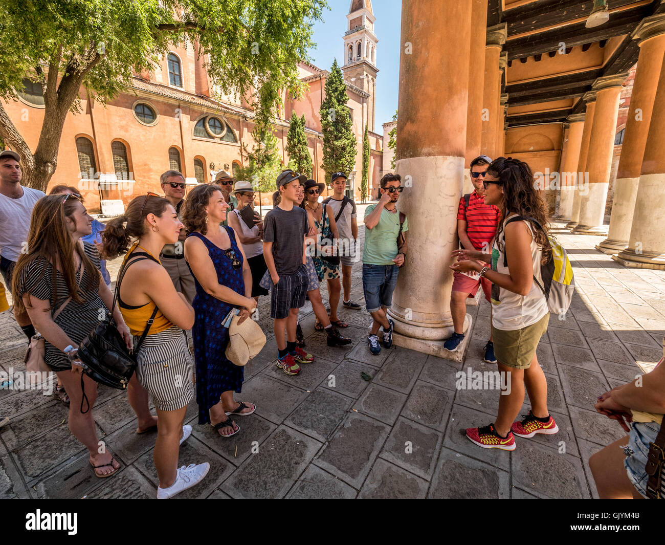 Tour guide addressing a group of tourists on a sustainable tourism ...