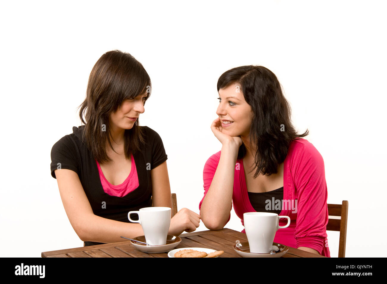 two women in conversation at the coffee table Stock Photo - Alamy