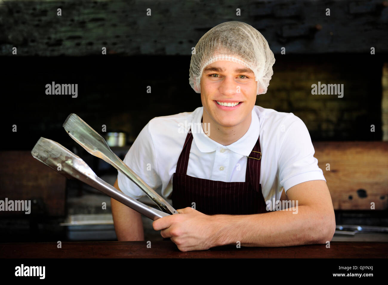 man working at a restaurant with wood-burning oven Stock Photo - Alamy