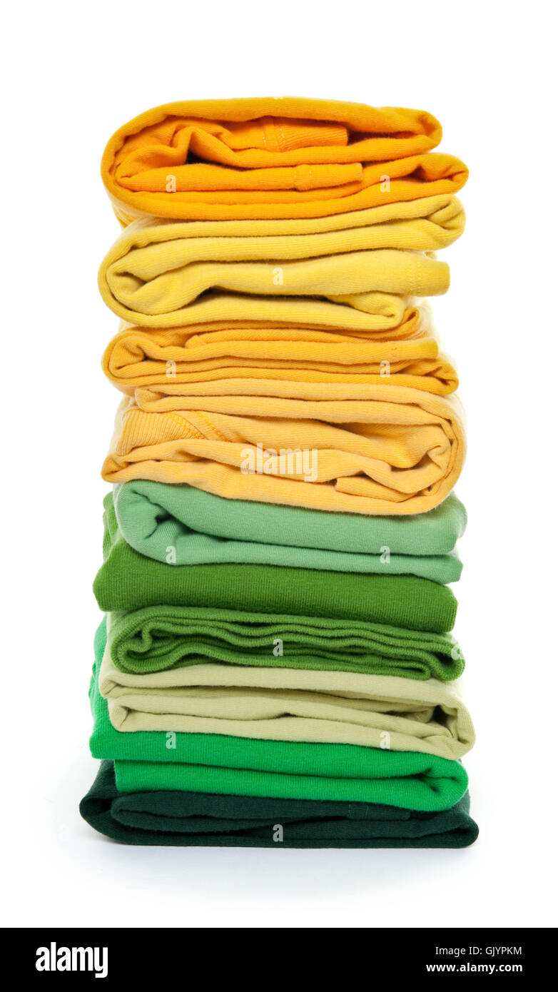 Pile of green and yellow folded clothes Stock Photo - Alamy