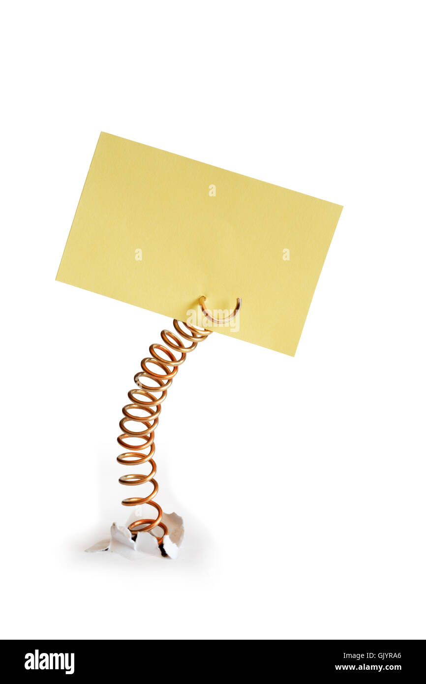 Metal Spring With Yellow Note Pad Stock Photo - Alamy