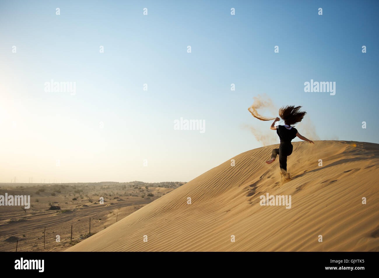 Woman in the desert Stock Photo - Alamy