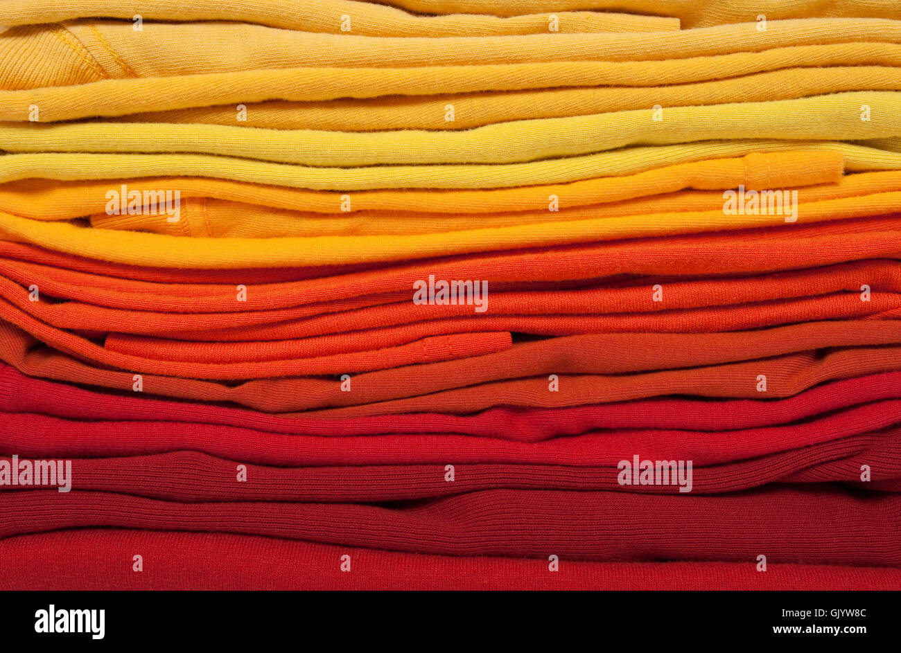 Folded red, orange and yellow clothes Stock Photo - Alamy