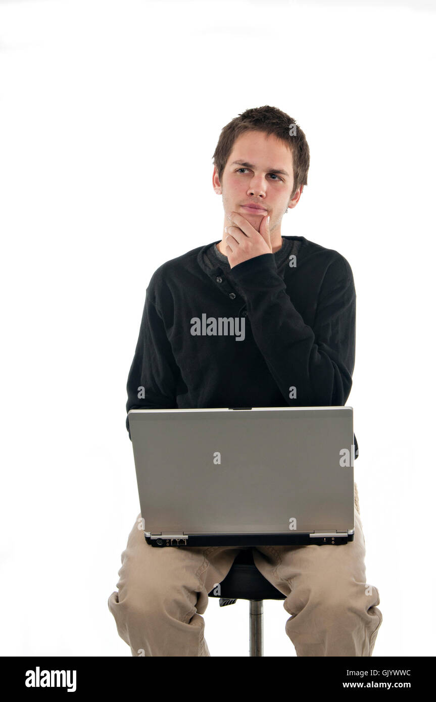 teenager sitting on stool with laptop Stock Photo - Alamy