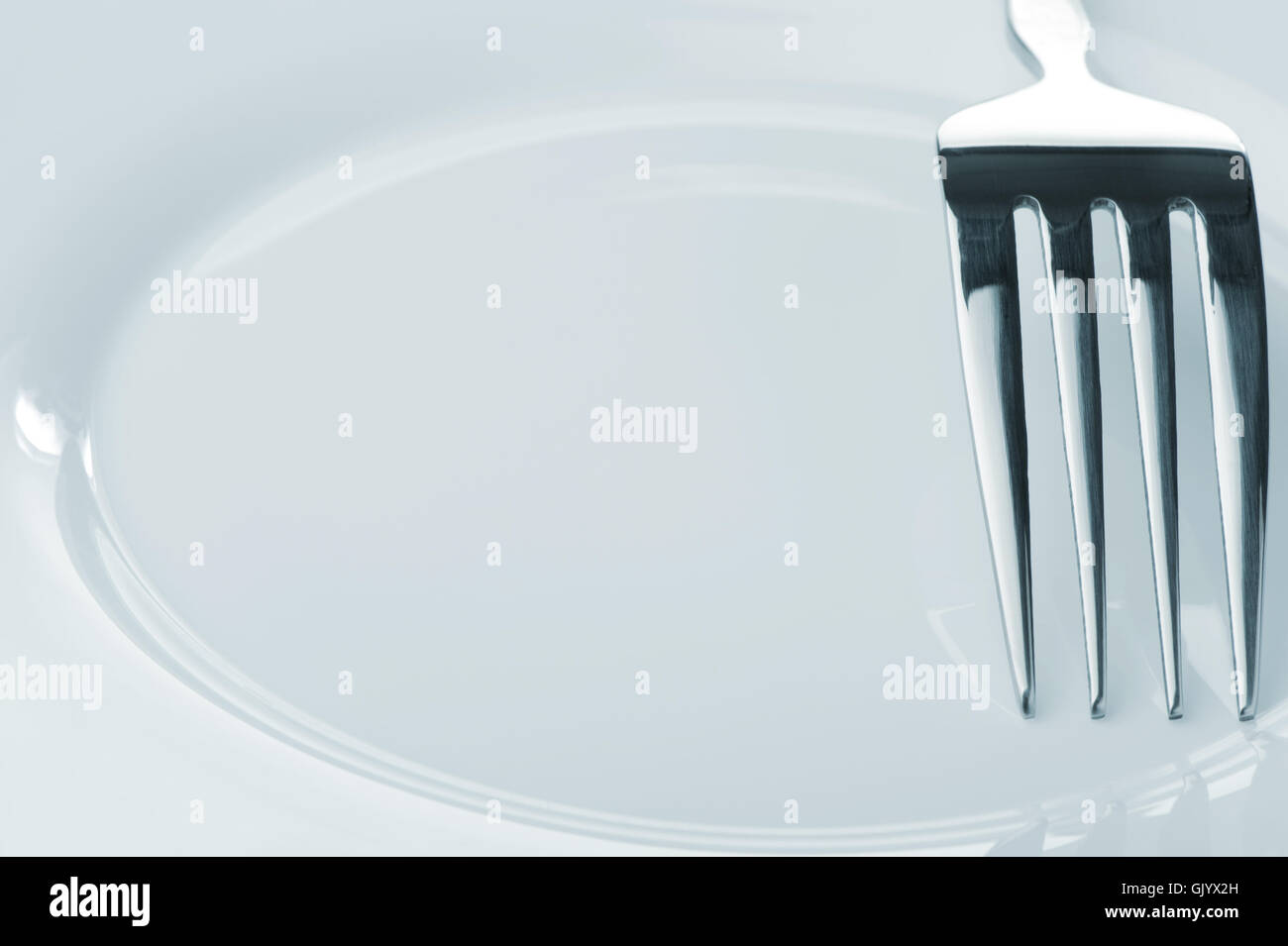 fork on a plate Stock Photo - Alamy