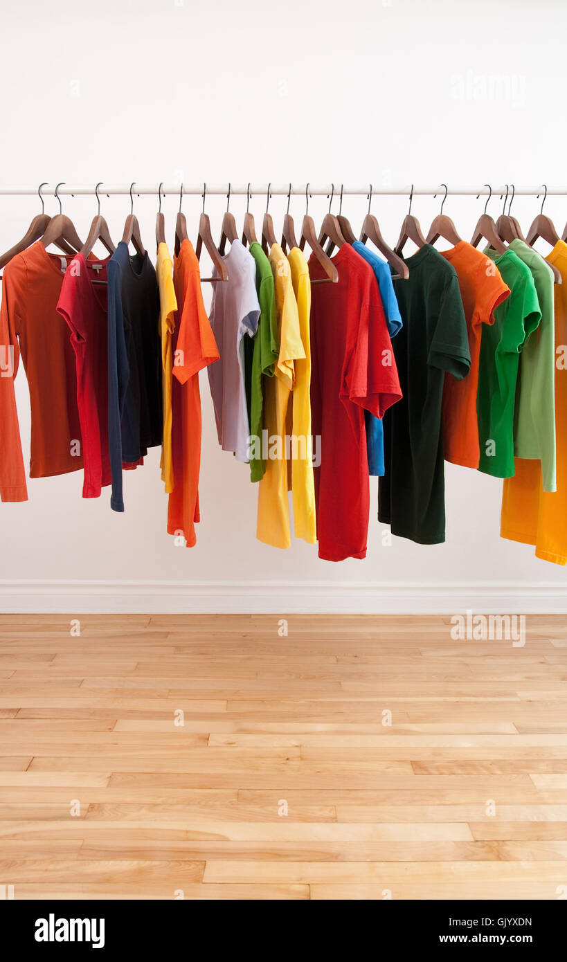 Variety of multicolored clothes on a rod Stock Photo - Alamy