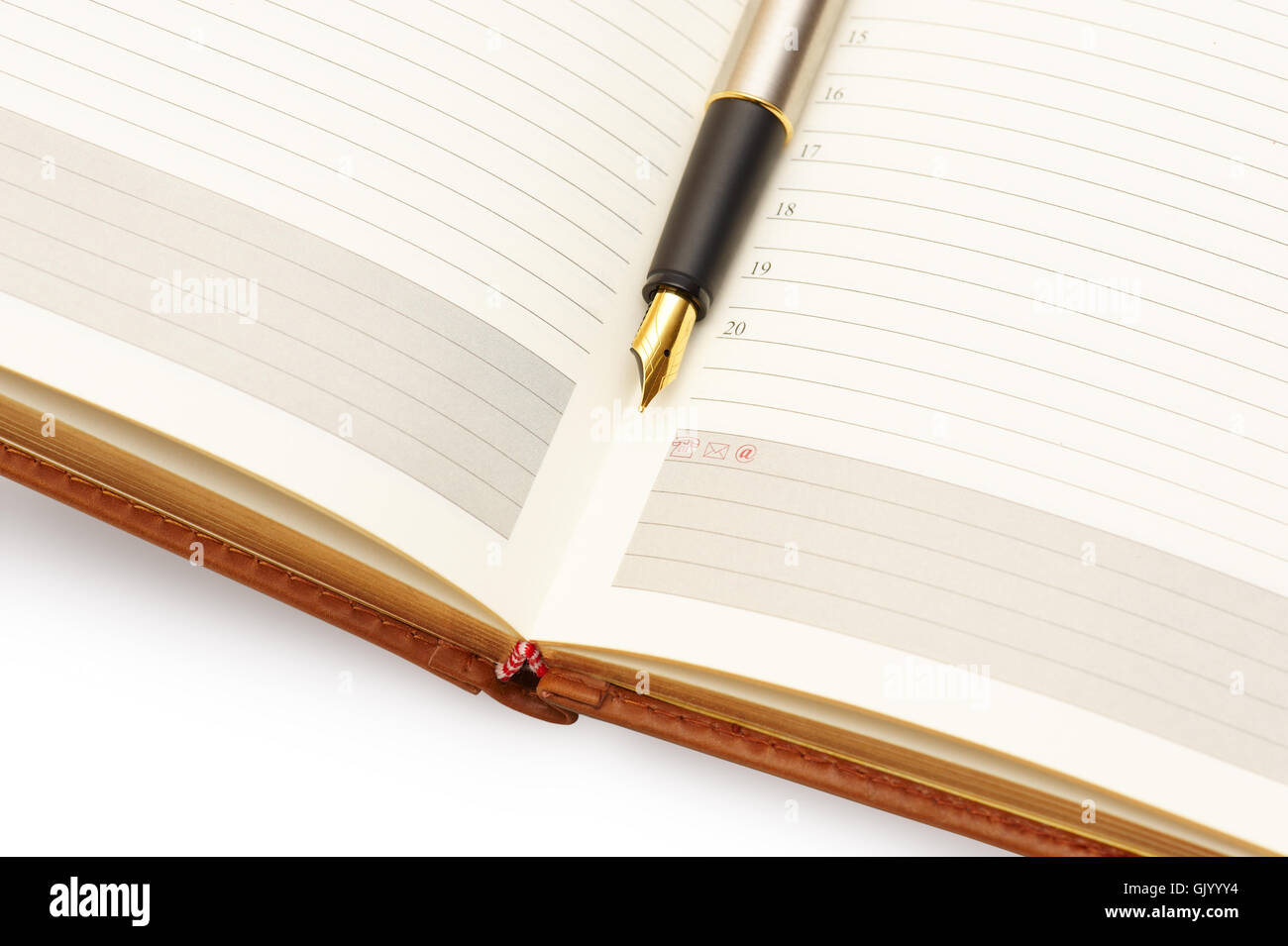 Gold pen on diary Stock Photo - Alamy